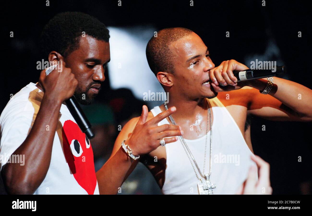 Rappers Clifford Harris Jr. aka T.I. and Kanye West (L) perform at a ...