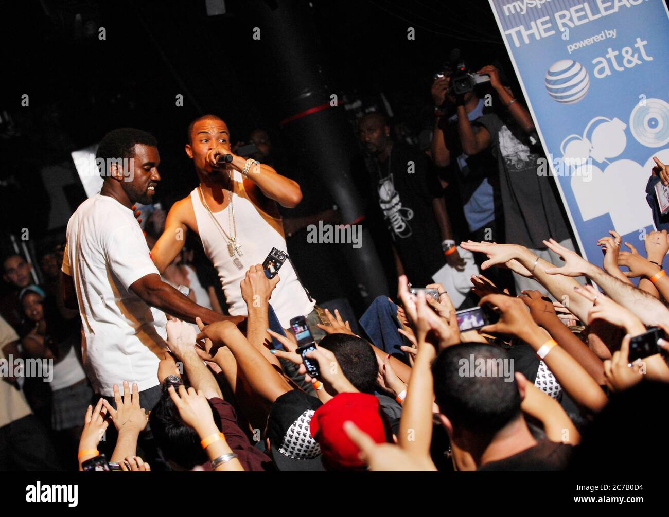 Rappers Clifford Harris Jr. aka T.I. and Kanye West (L) perform at a ...