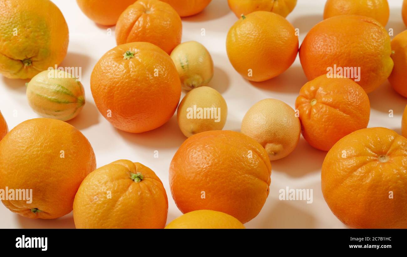 Oranges and lemons on white background. Fresh ripe fruits close up ...