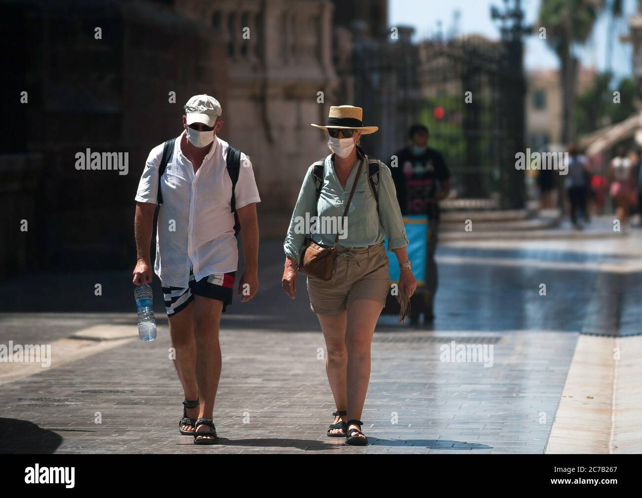 Malaga, Spain. 15th July, 2020. A couple of tourists wearing face masks ...