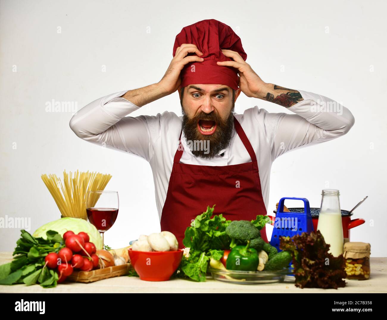 Professional cookery concept. Chef prepares meal. Cook with scared face ...