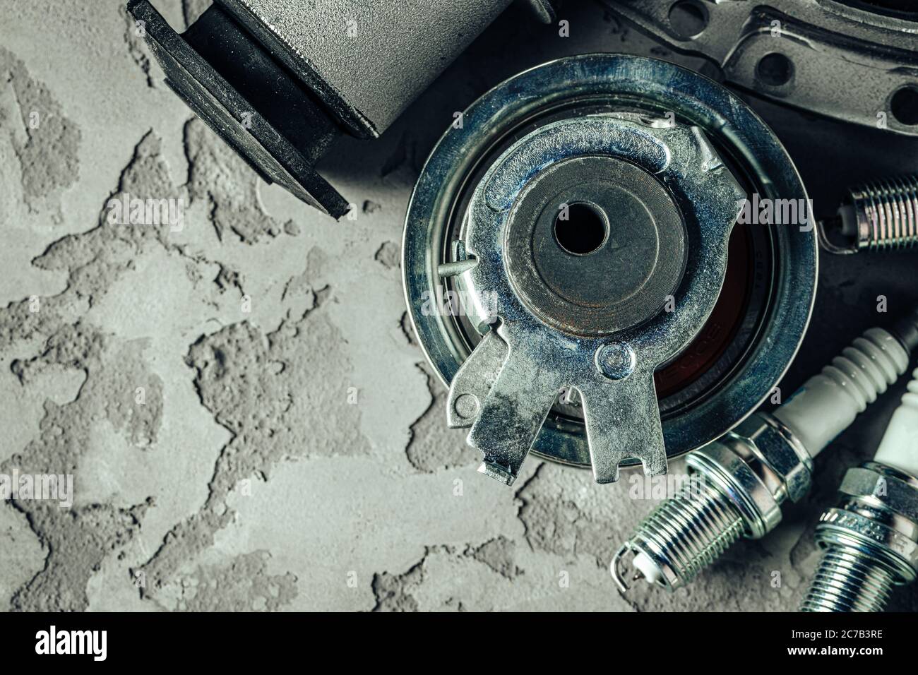 Car parts on grey textured concrete background Stock Photo - Alamy