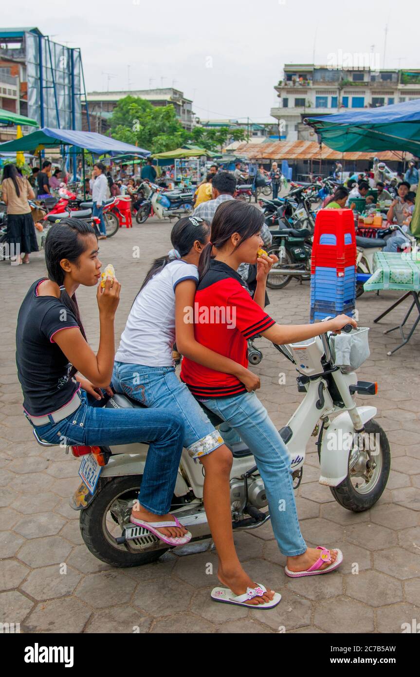 A street scene with girls on a moped in Phnom Penh, the capital city of ...