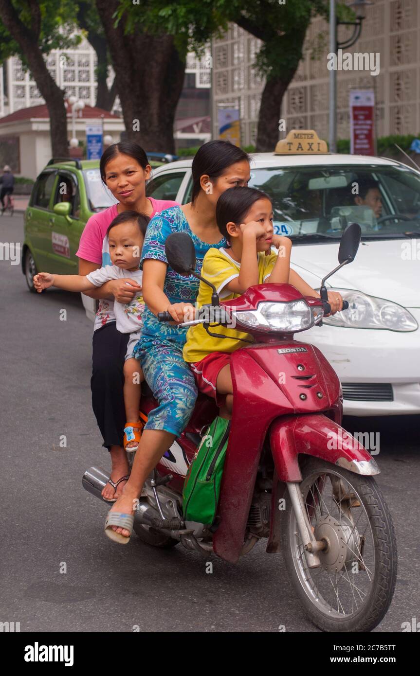 A street scene with a family on a moped in Hanoi in North Vietnam Stock ...