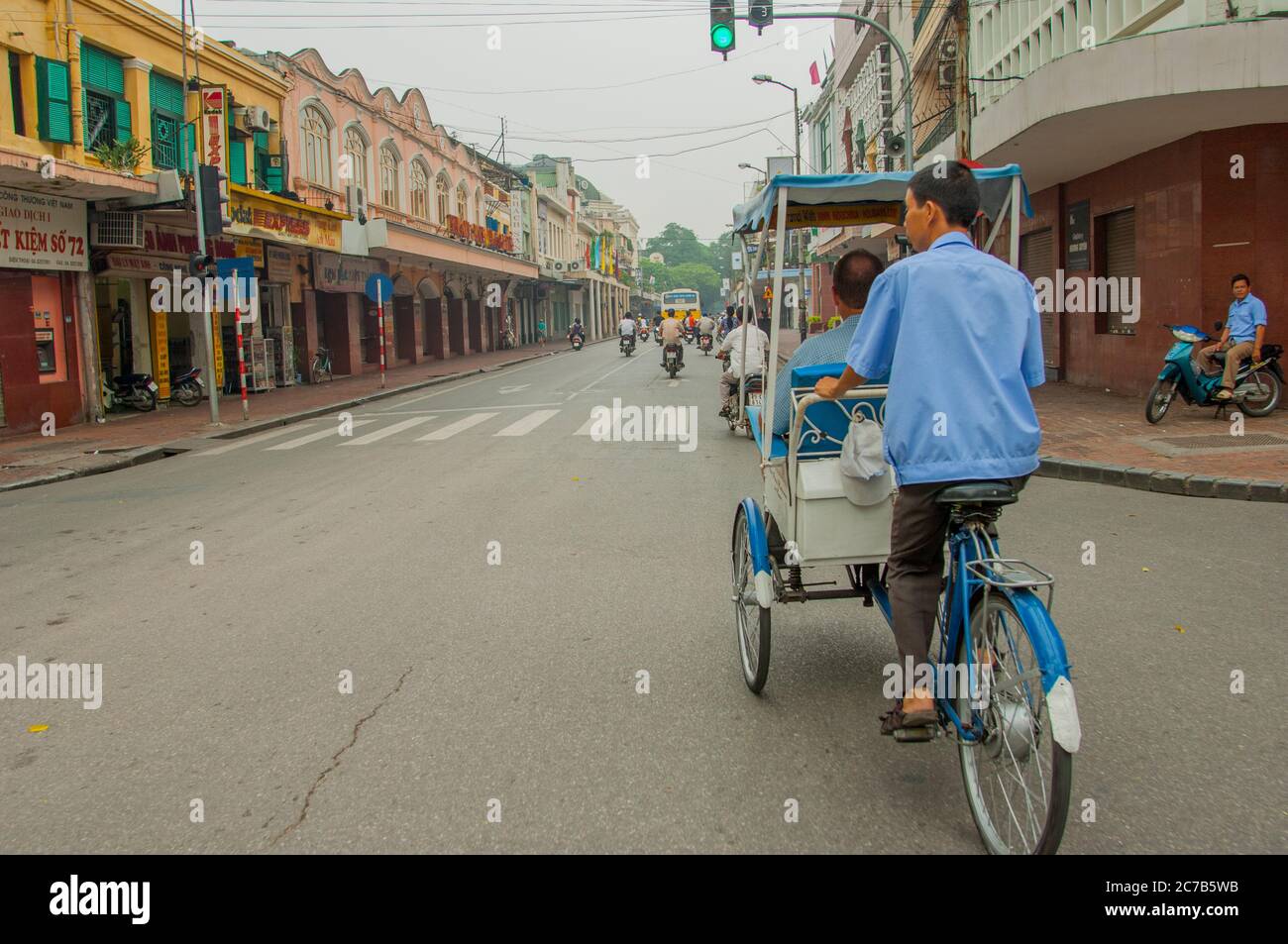 A street scene with a bicycle rickshaw in Hanoi in North Vietnam Stock ...