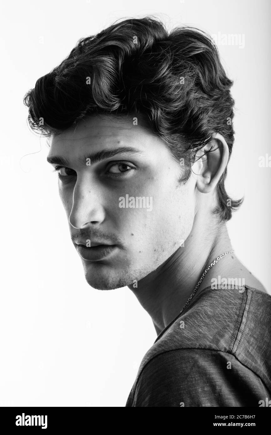 Face of young handsome man looking back Stock Photo - Alamy