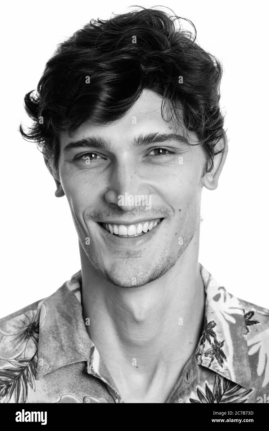 Face of young happy handsome man smiling wearing Hawaiian shirt Stock ...