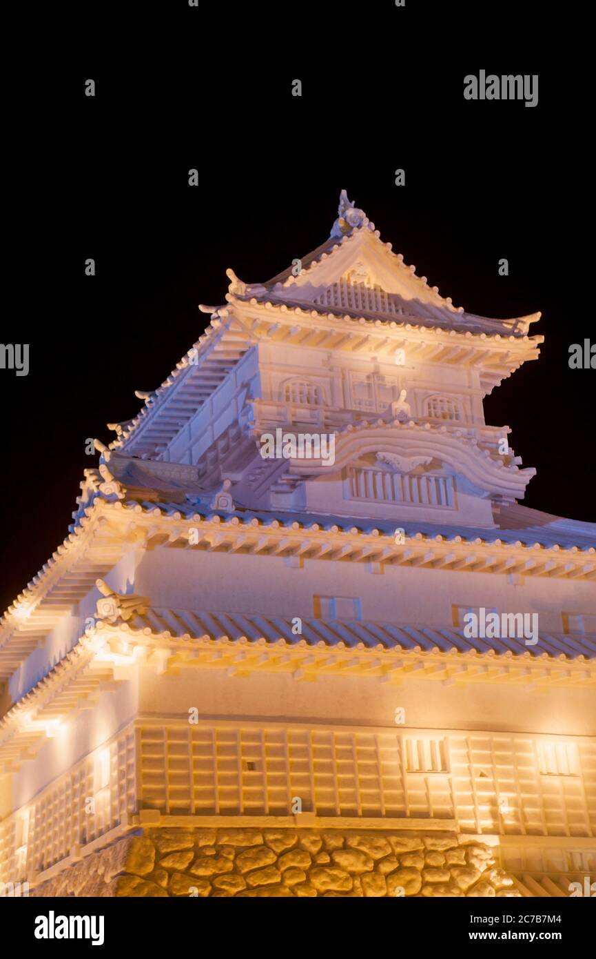 A Japanese castle ice sculpture illuminated at night at the Sapporo ...