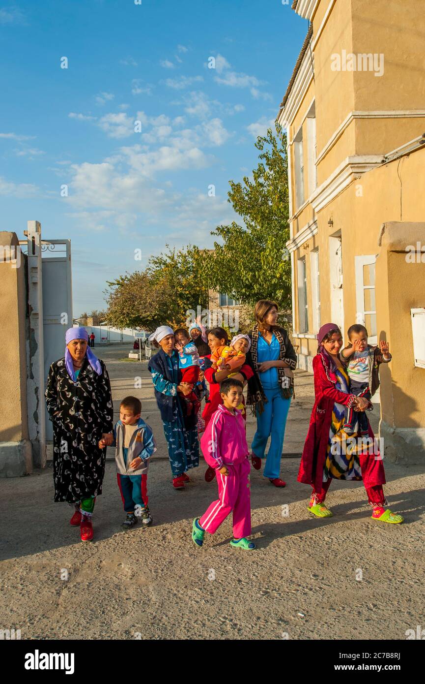 Local people walking on a street in the historic city of Bukhara ...