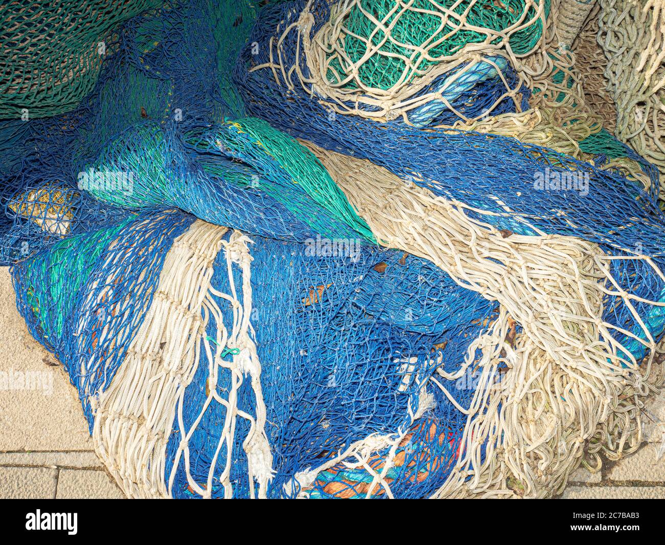 Fishing gear and equipment in the port. Lay out various fishing nets ...