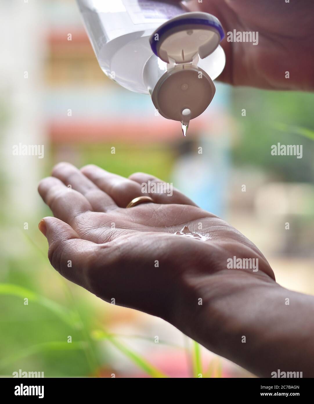 Woman applying hand sanitizer, washing hands with alcohol gel or ...