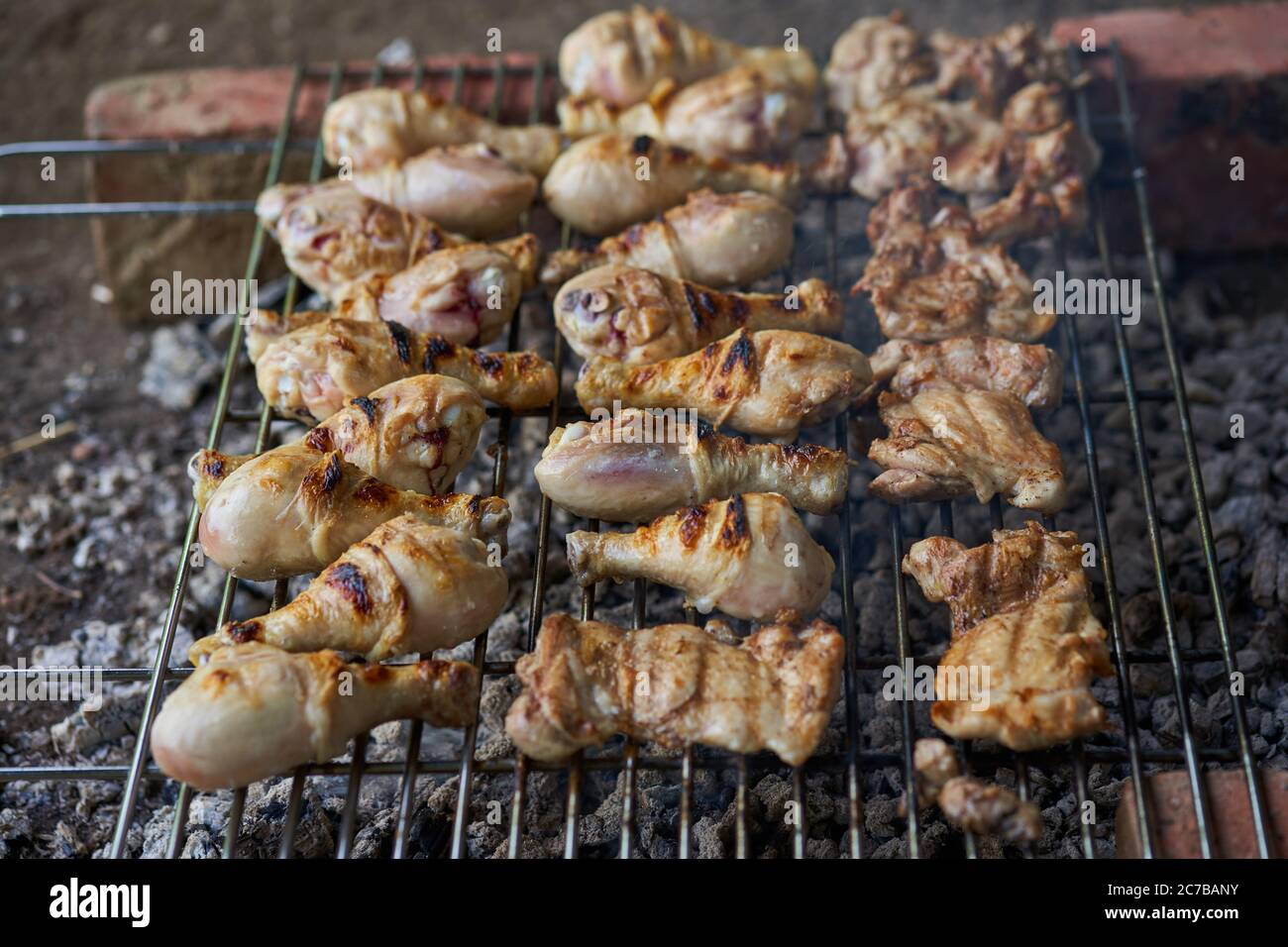 Closeup of a barbecue grill with drumstick and meat rolls Stock Photo ...