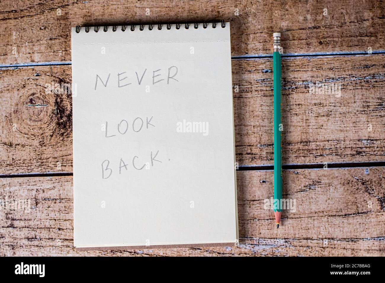 Notebook and green pencil, Never look back. Motivational phrases and ...