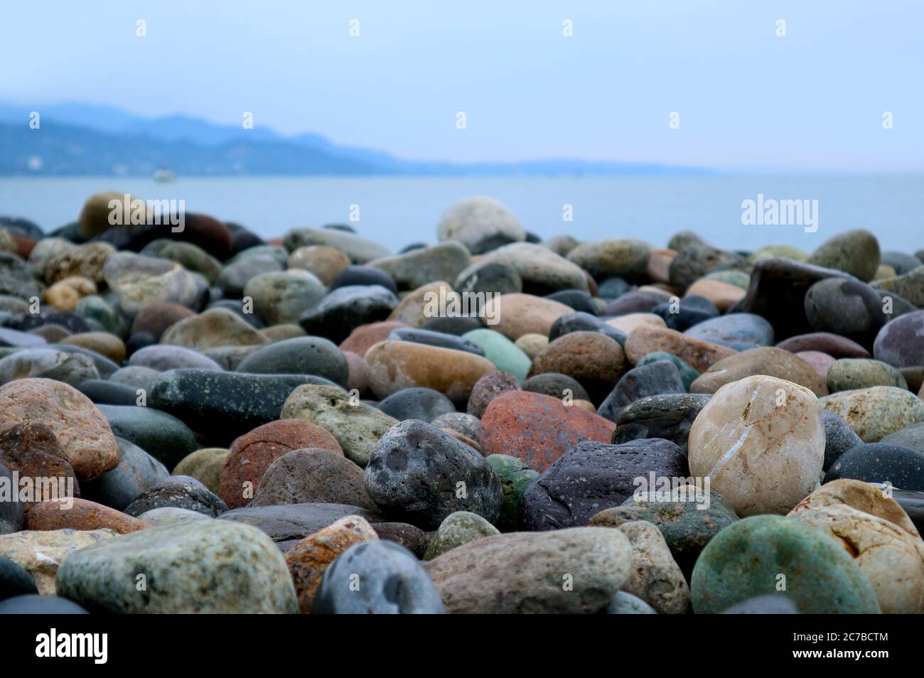 Closeup Multi-color Natural Pebble Stones on the Beach with Blurry ...