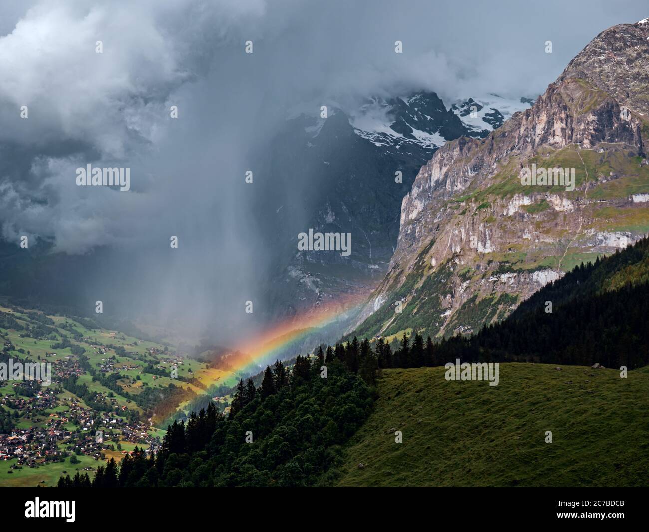 Aerial shot of a rainbow breaking behind a storm cloud in the alpine ...
