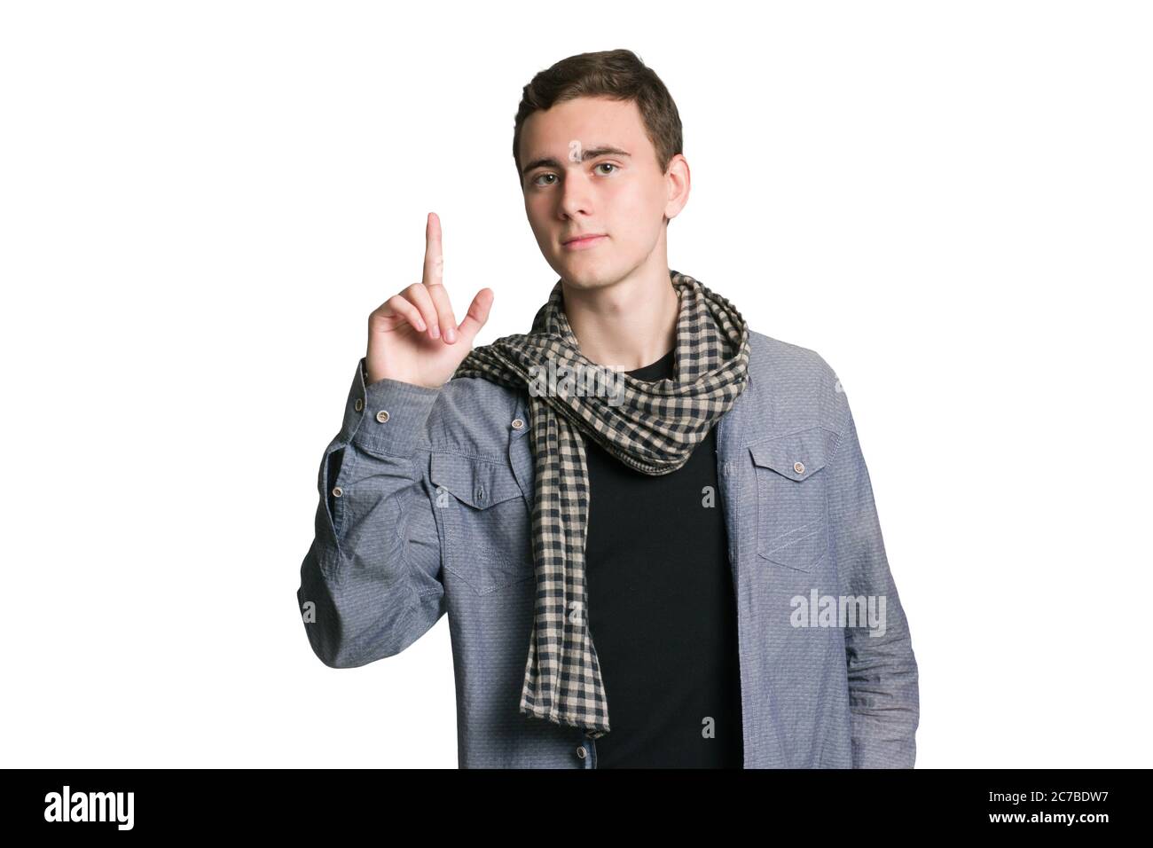 A young man in a Manatee shirt, black t-shirt and trousers, plaid scarf ...