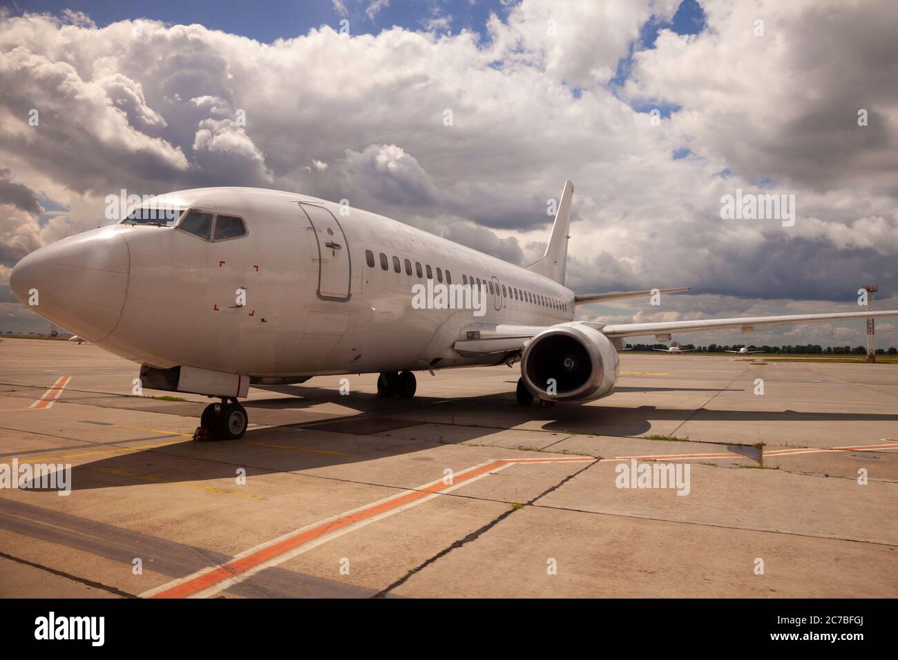 A white plane stands on the airport platform near the runway. Layout ...