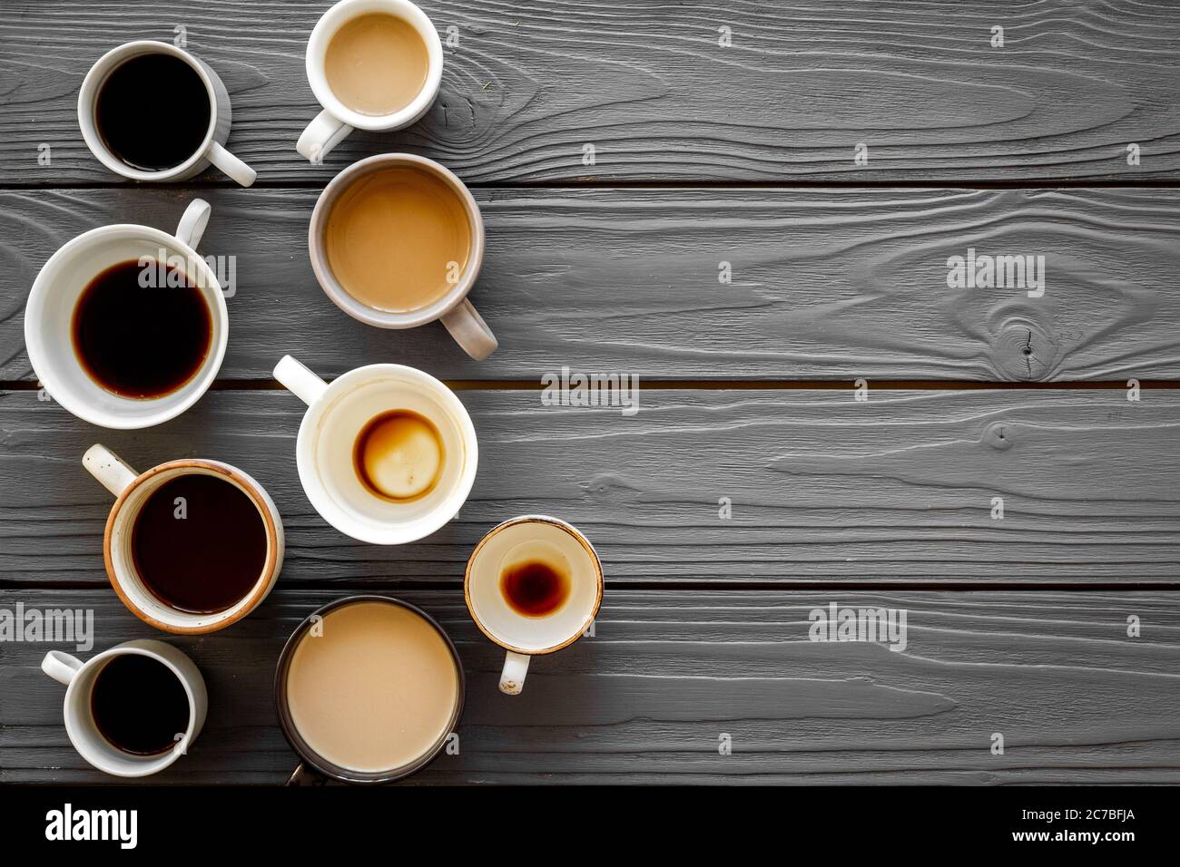 Coffee addiction. Many of cups on wooden table top view space for text ...