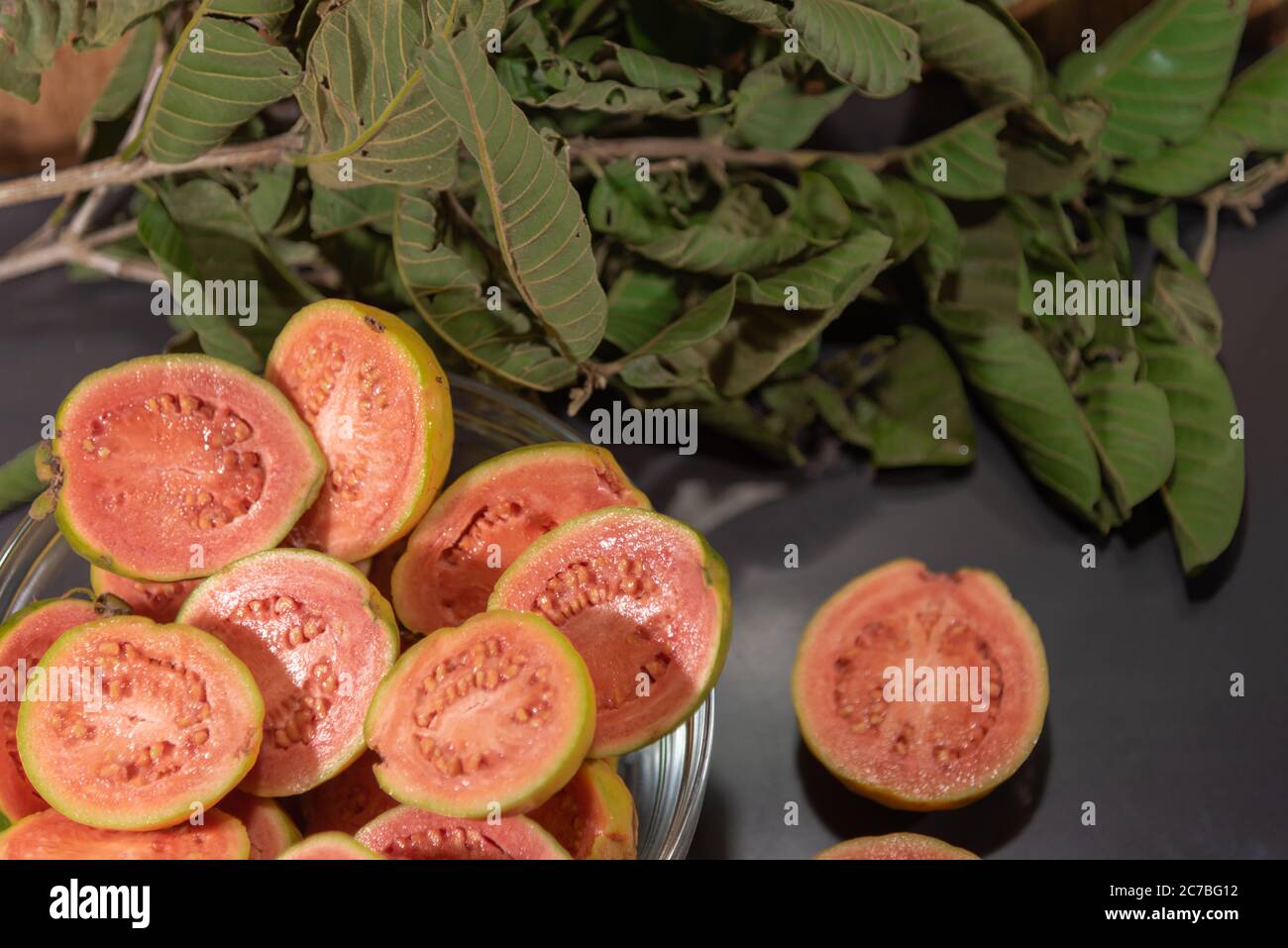 Guava fruits in halves. Guava is the fruit of guava, a tree of the ...