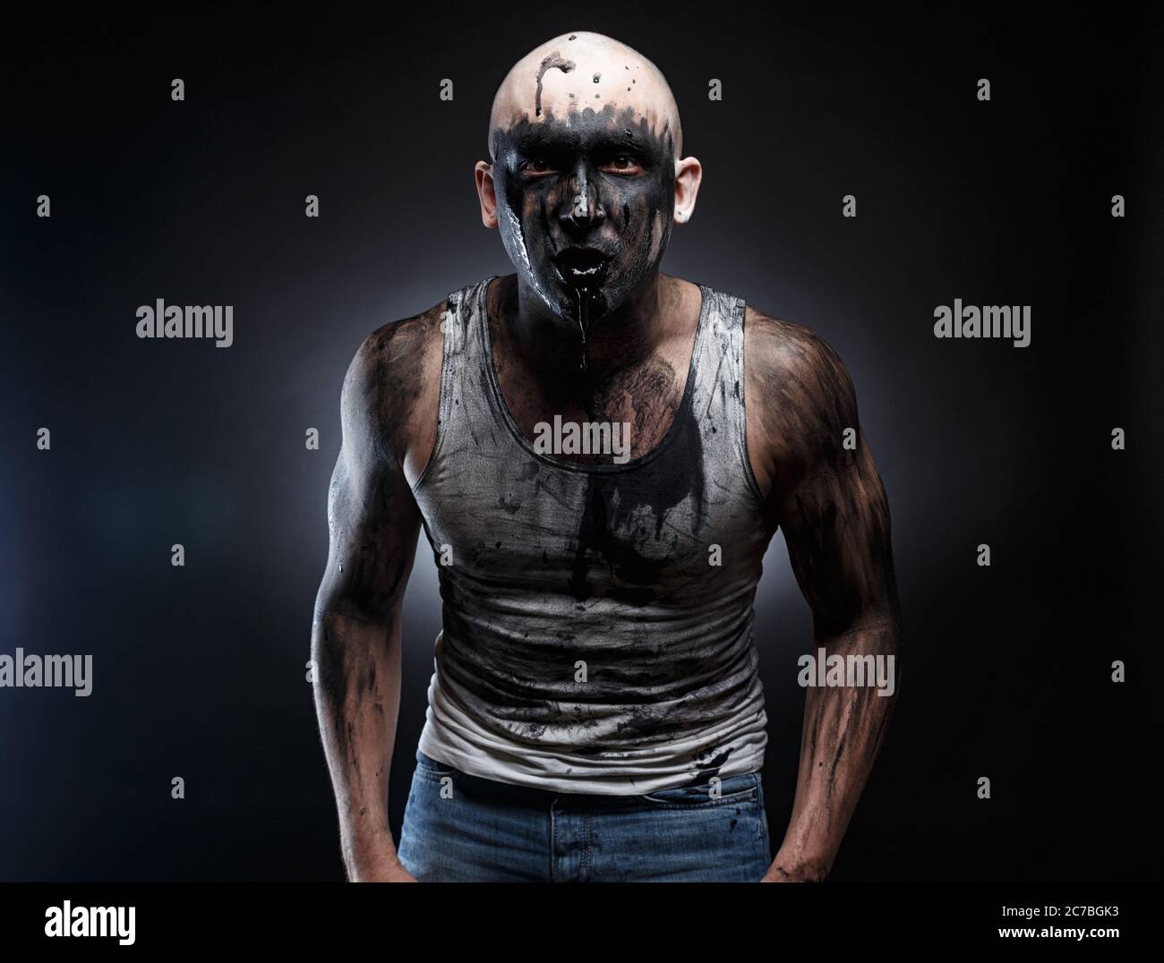 Photo of dirty mad man with black muck in the mouth Stock Photo - Alamy