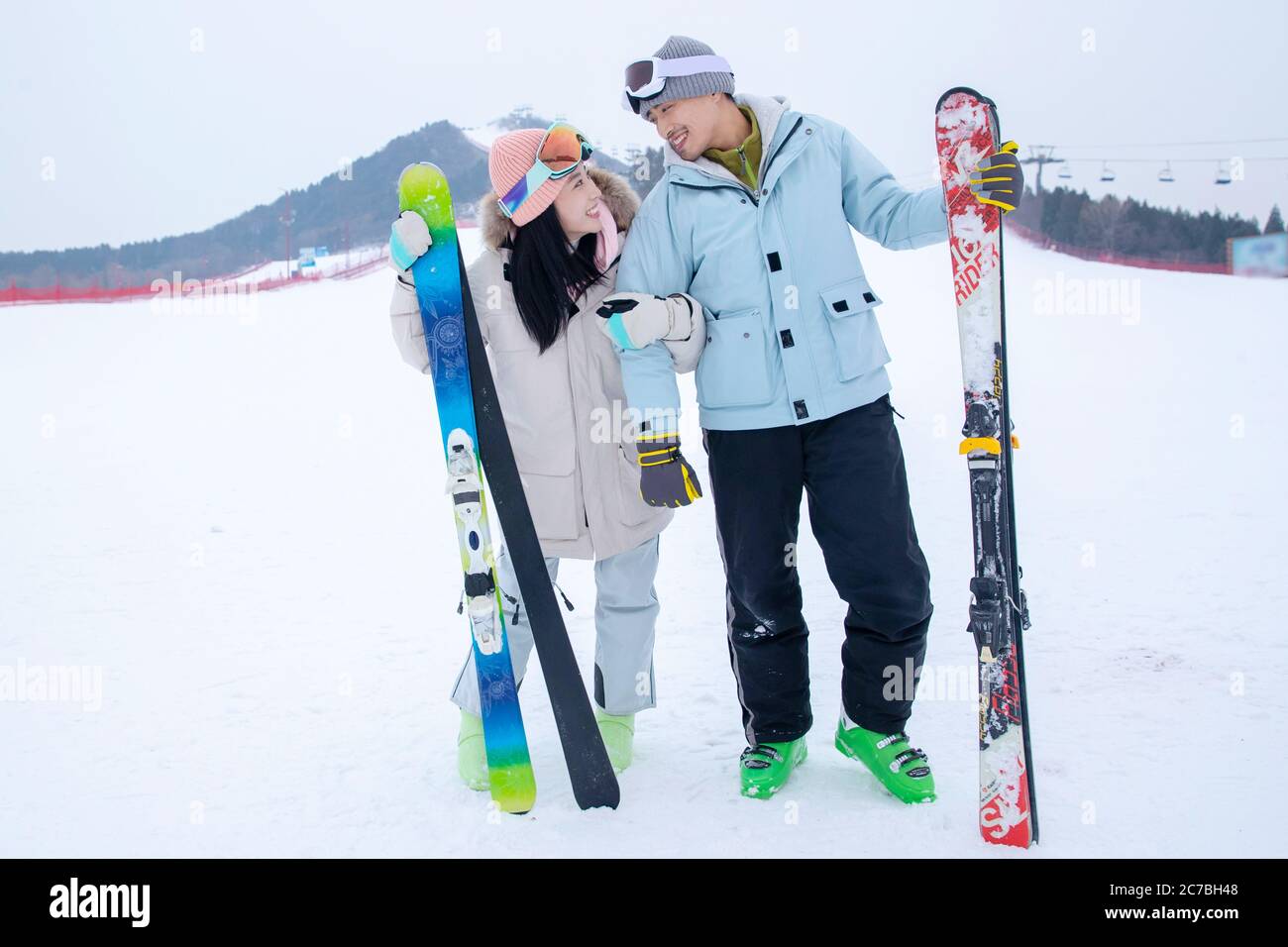 Skiing field station of young couples Stock Photo - Alamy