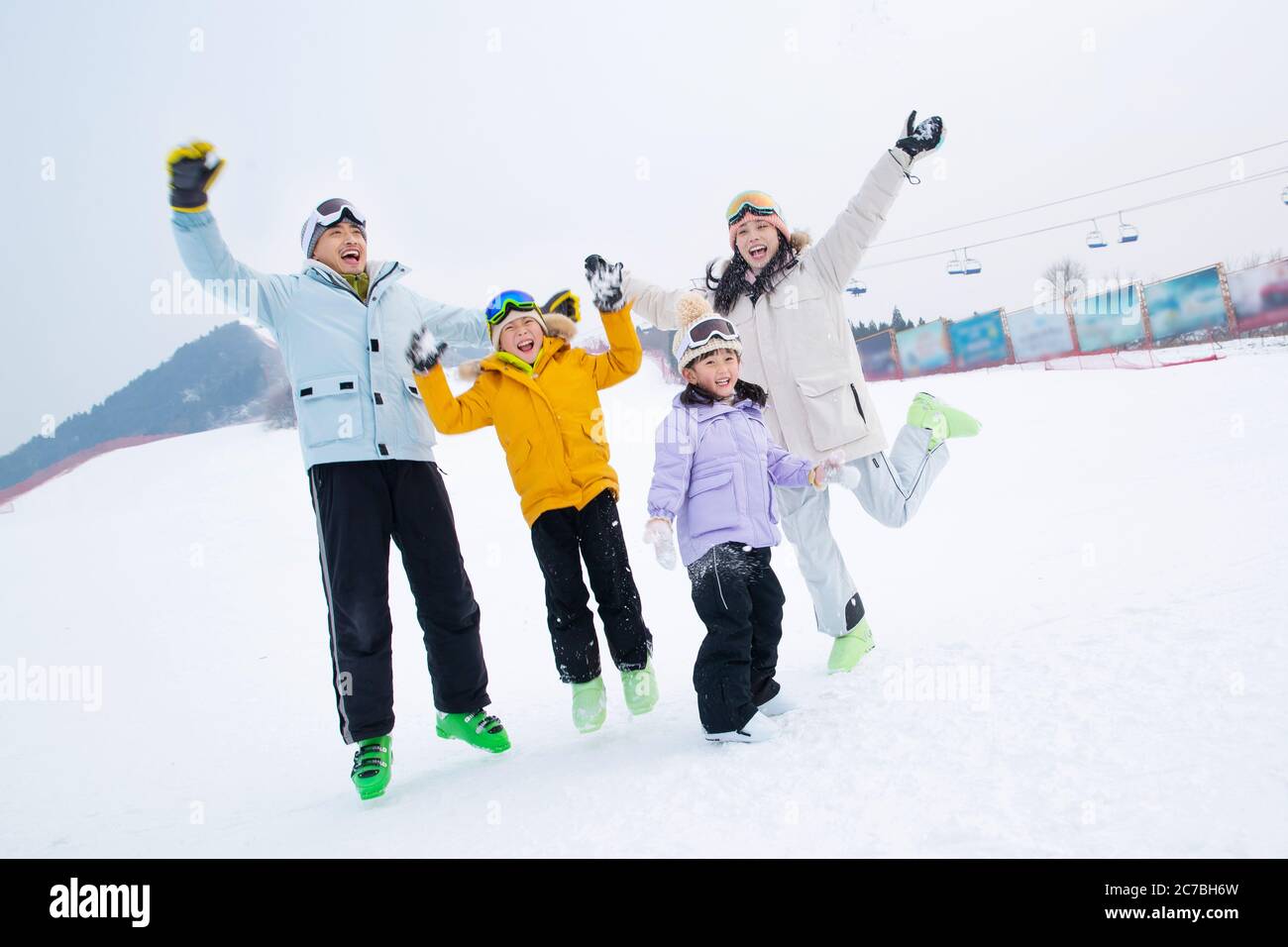 Happy family play in the snow Stock Photo - Alamy