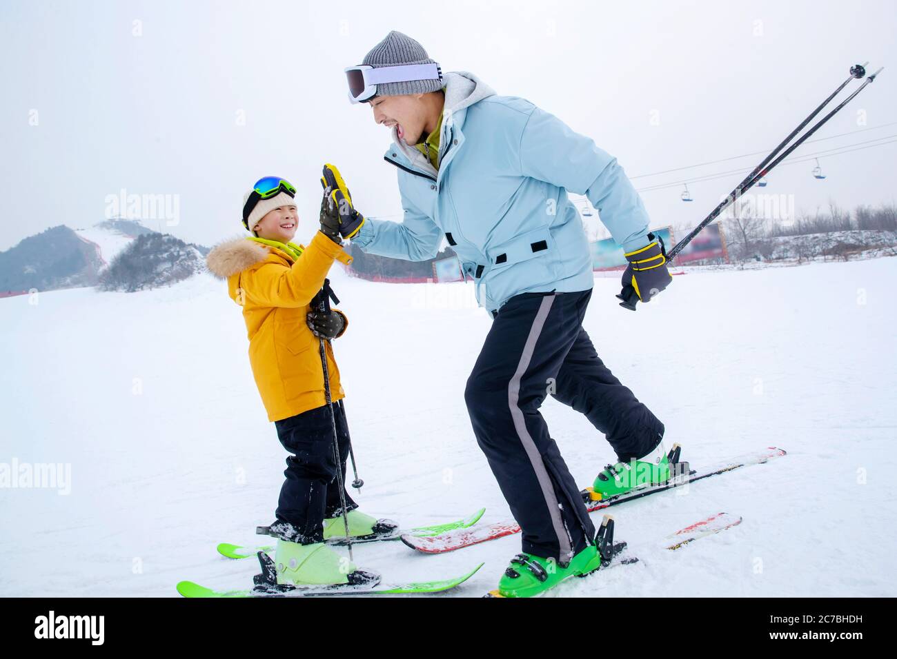 Ski hand-clapping happy father and son Stock Photo - Alamy