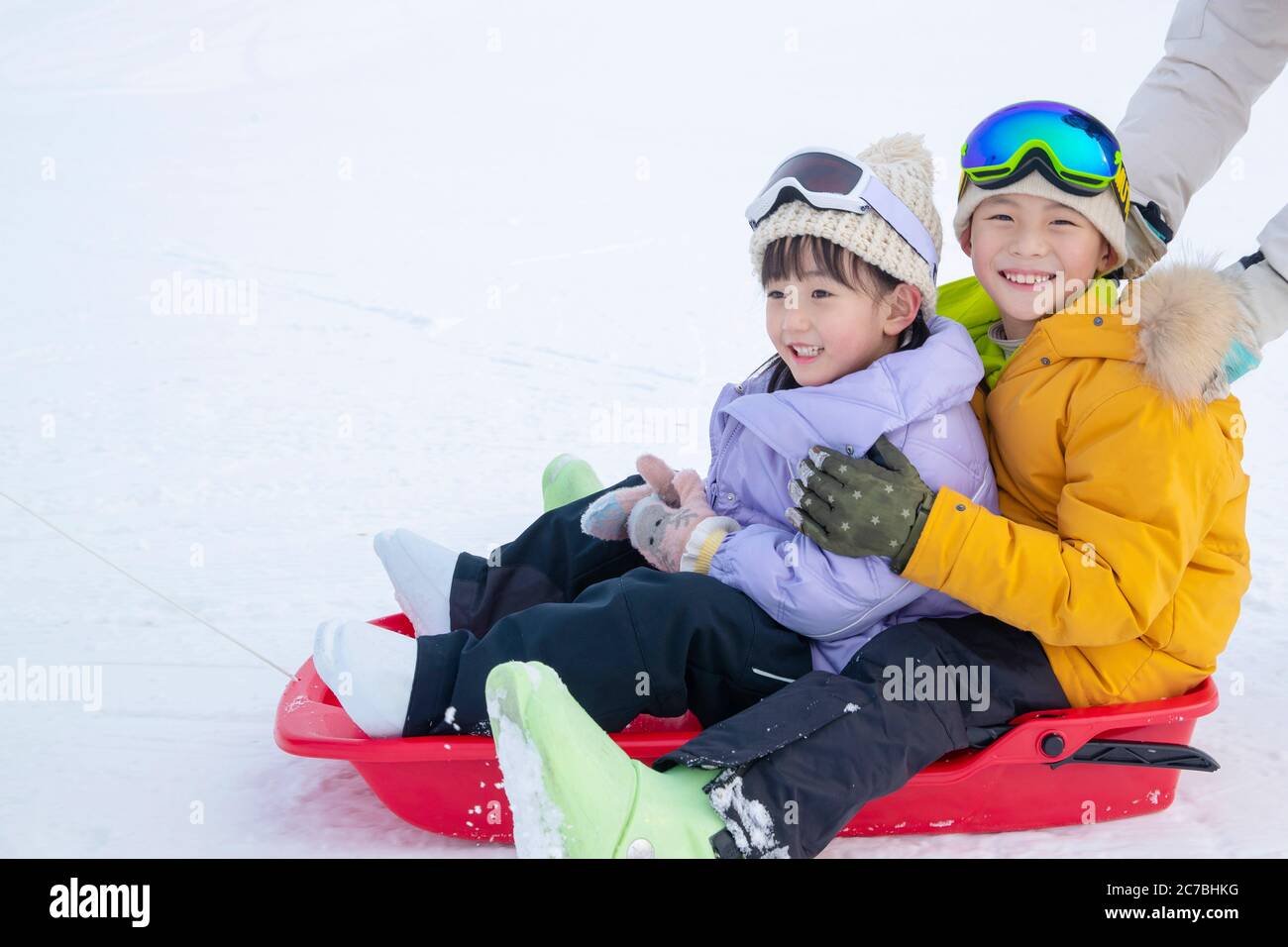 Ski resorts in pushing children sitting in the snow slide Stock Photo ...