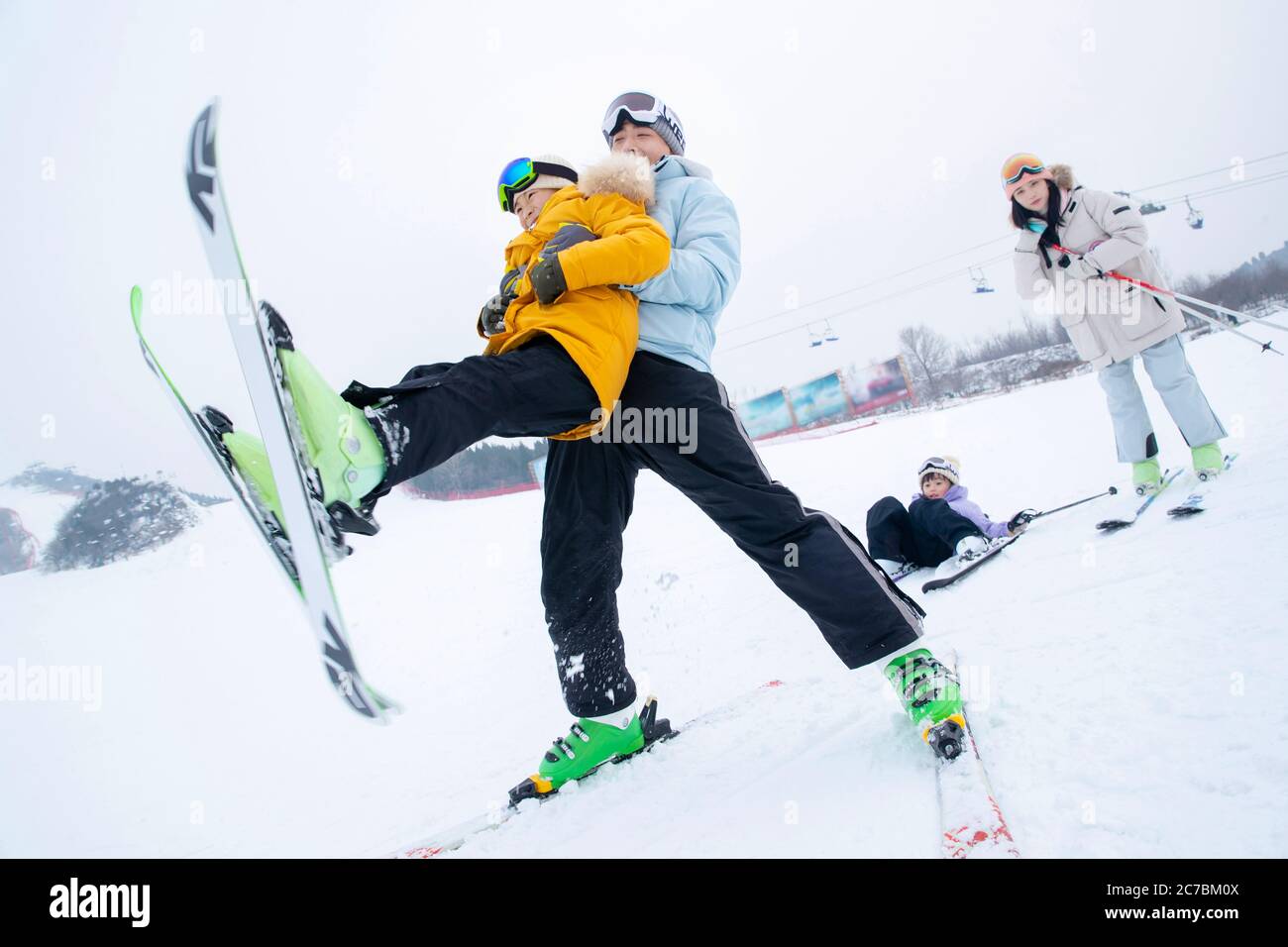 Skier skiing while playing a family of four Stock Photo - Alamy