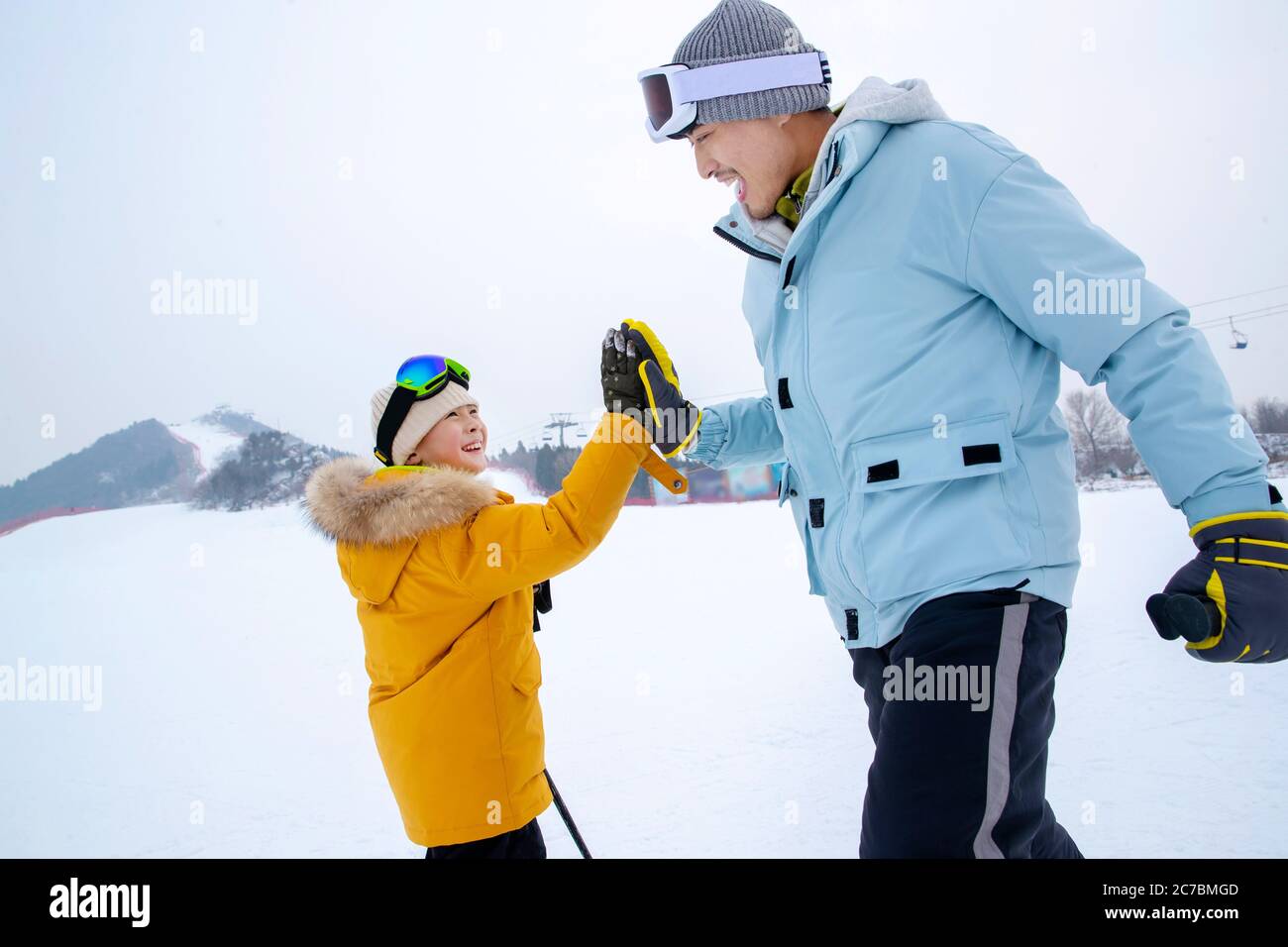 Ski hand-clapping happy father and son Stock Photo - Alamy