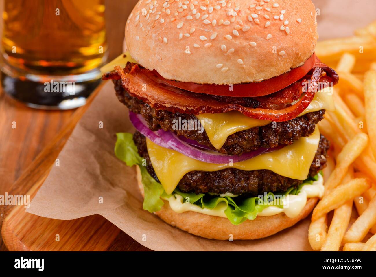Enormous double cheeseburger. Classic of fast food industry Stock Photo ...