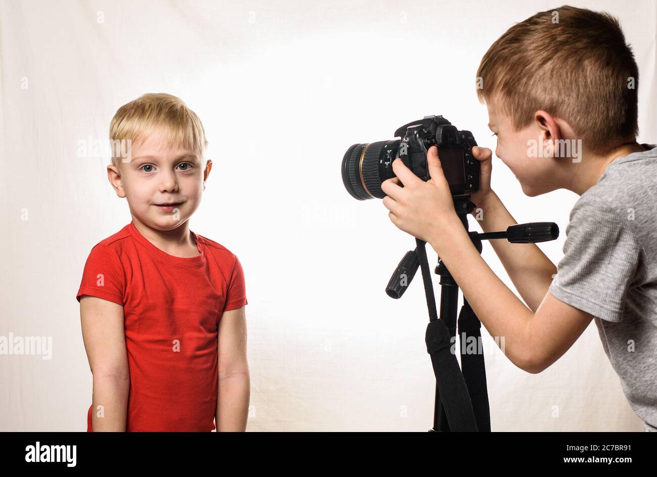 Little blond boy is ready to give the interview, boy takes it on video ...