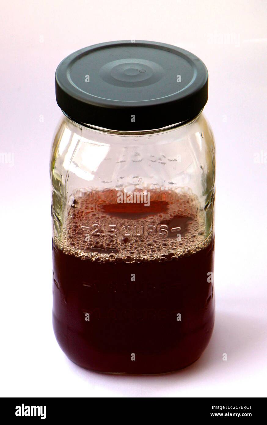 Sealed clear glass measuring jar with four measuring methods and a ...