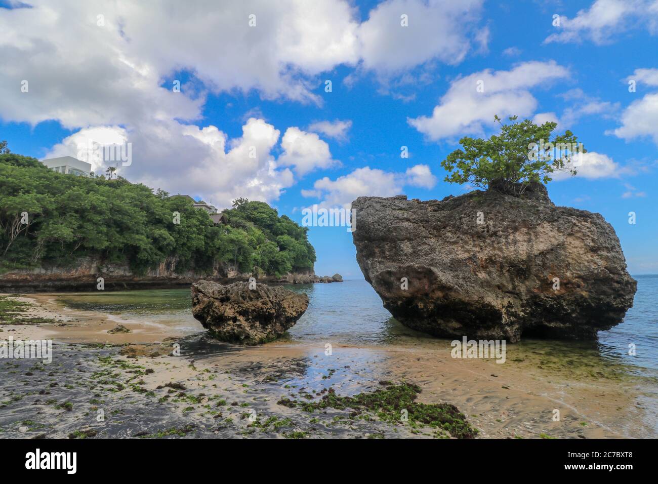 Sea with giant stones and sand island hi-res stock photography and ...