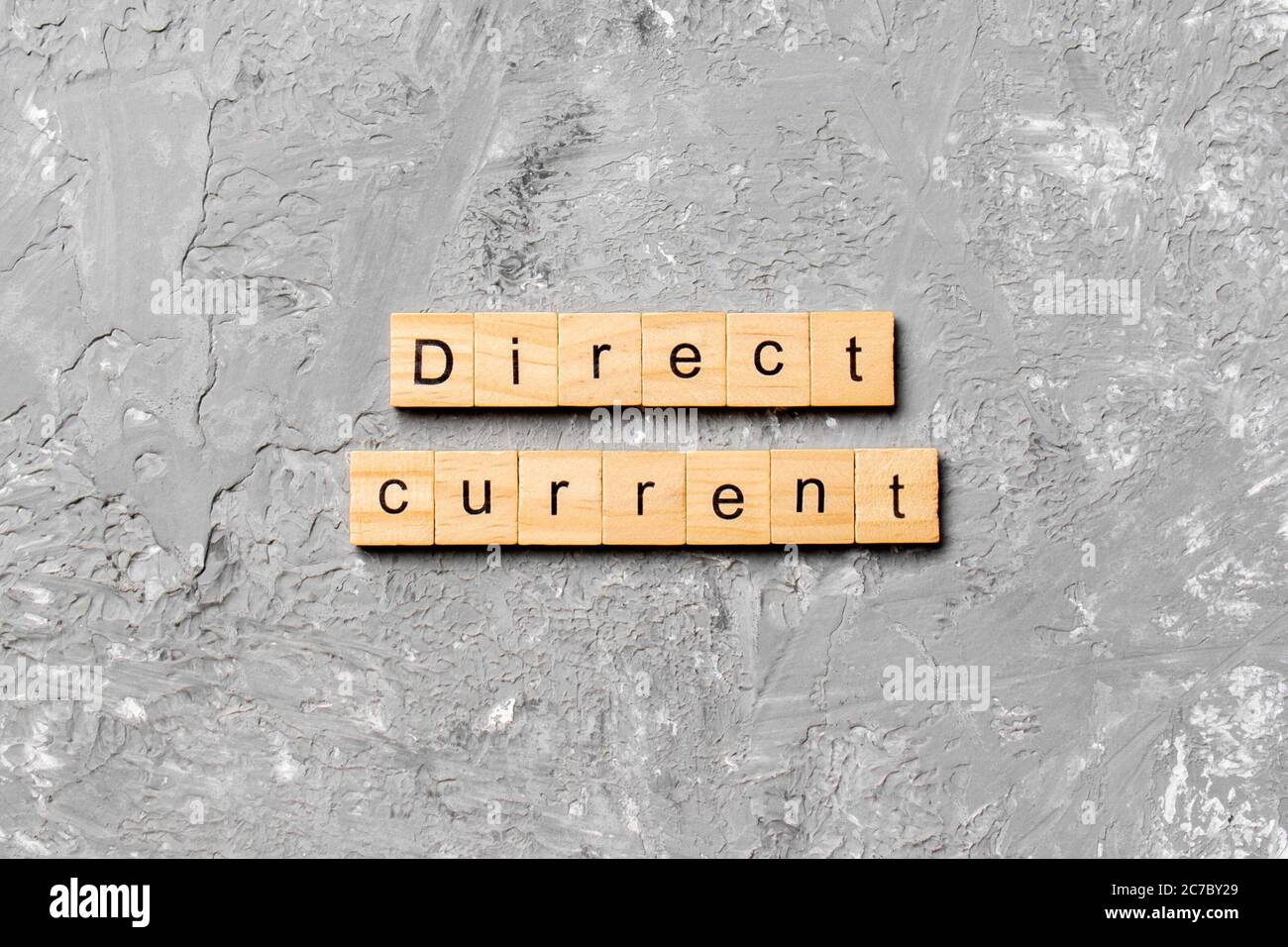 direct current word written on wood block. direct current text on ...