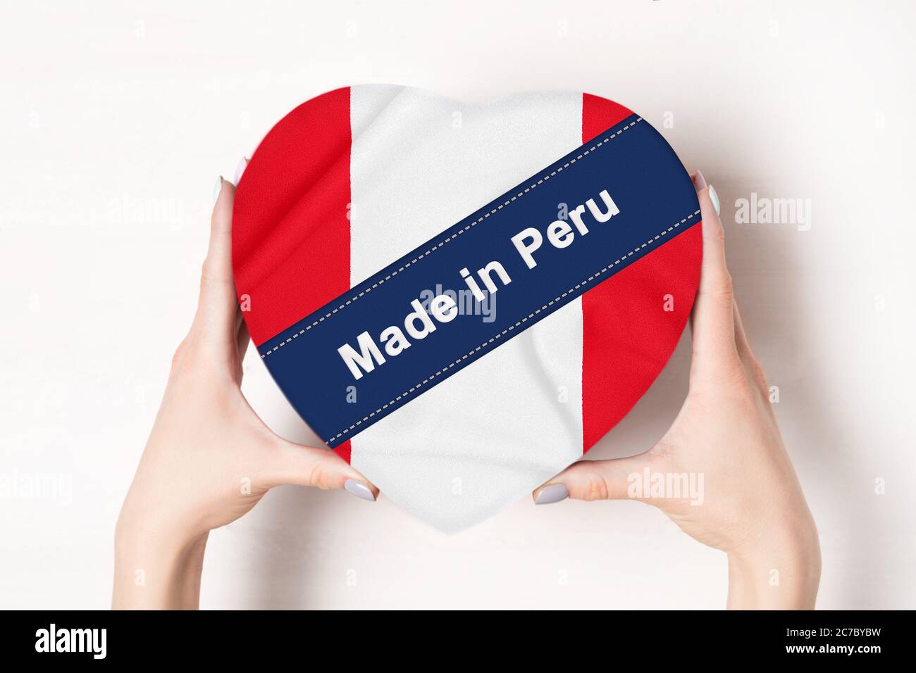 Inscription Made in Peru the flag of Peru. Female hands holding a heart ...