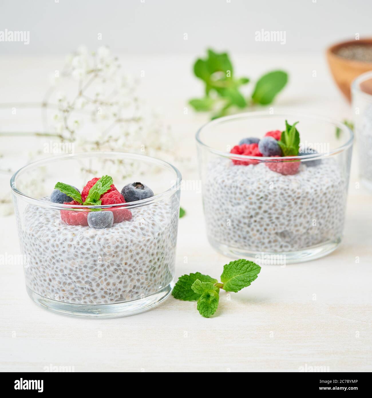 Chia pudding with fresh berries raspberries, blueberries. Two glass ...