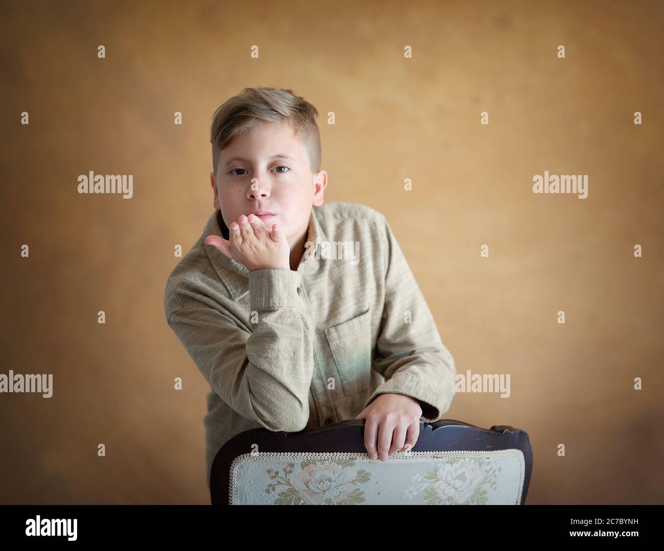 Portrait of happy teen boy blows air kissy. Child is sending you kiss ...