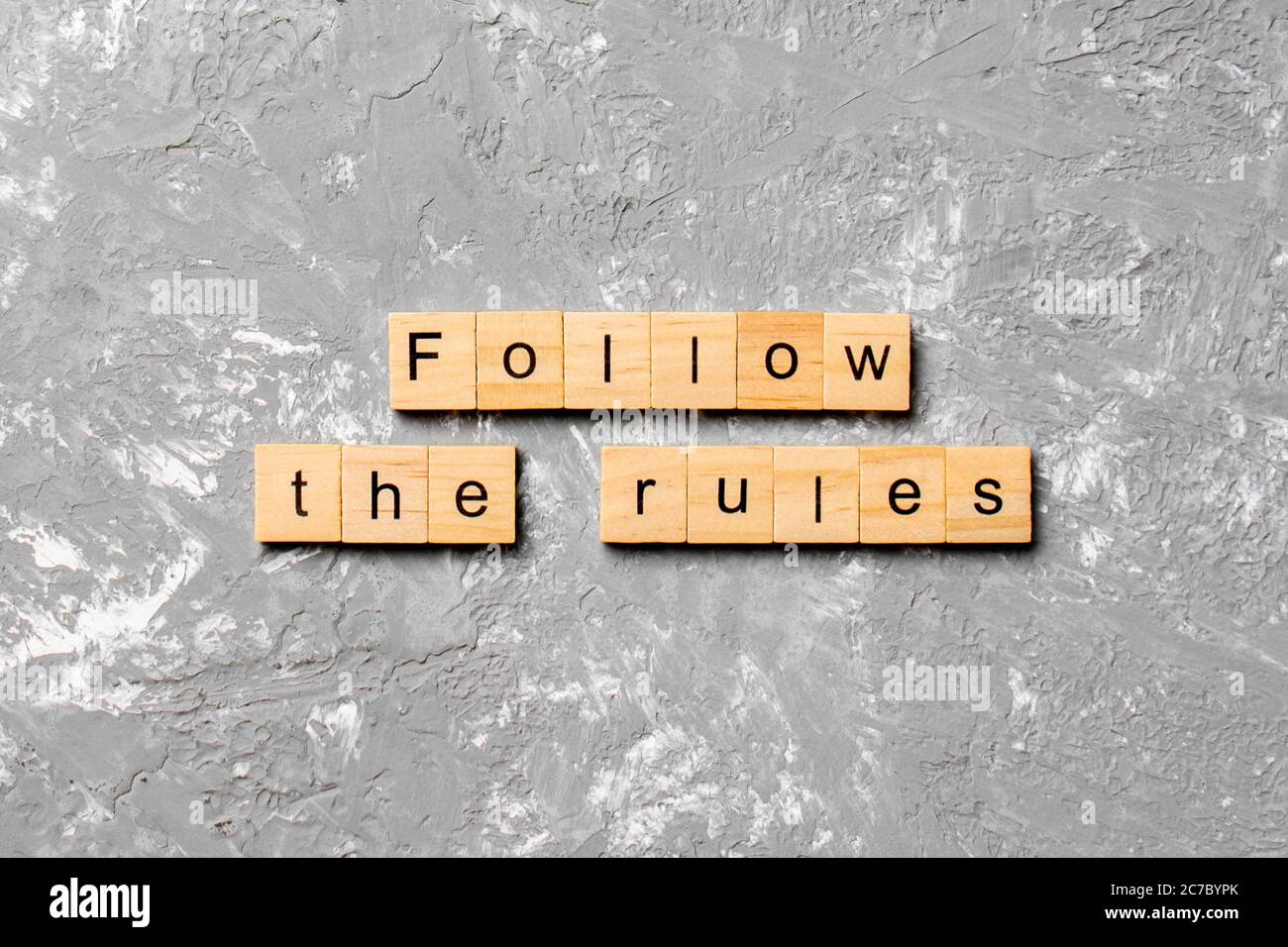 Follow The Rules word written on wood block. Follow The Rules text on ...