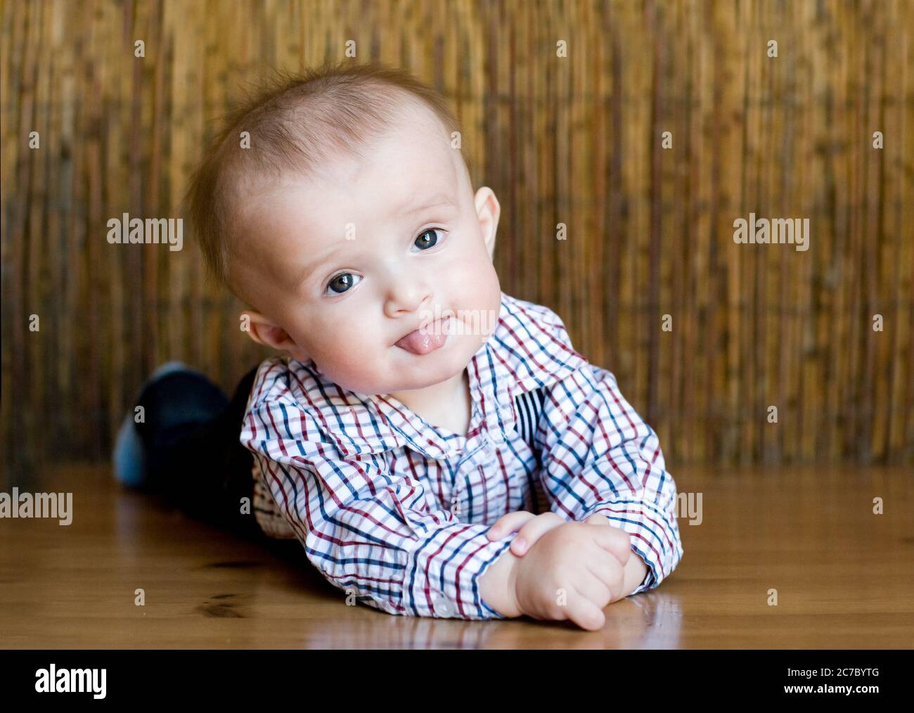The small cheerful kid lie on a floor Stock Photo - Alamy