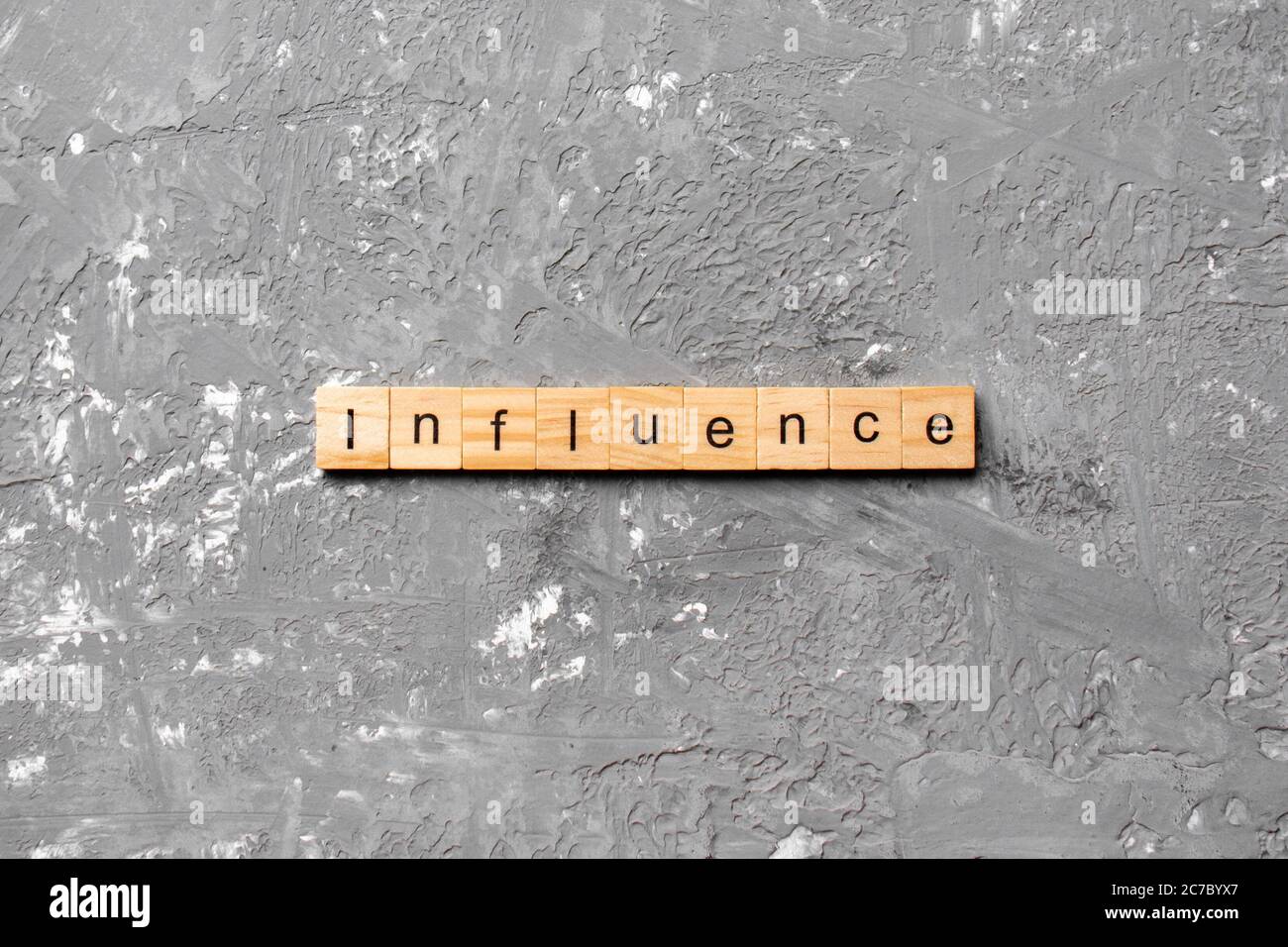 influence word written on wood block. influence text on table, concept ...