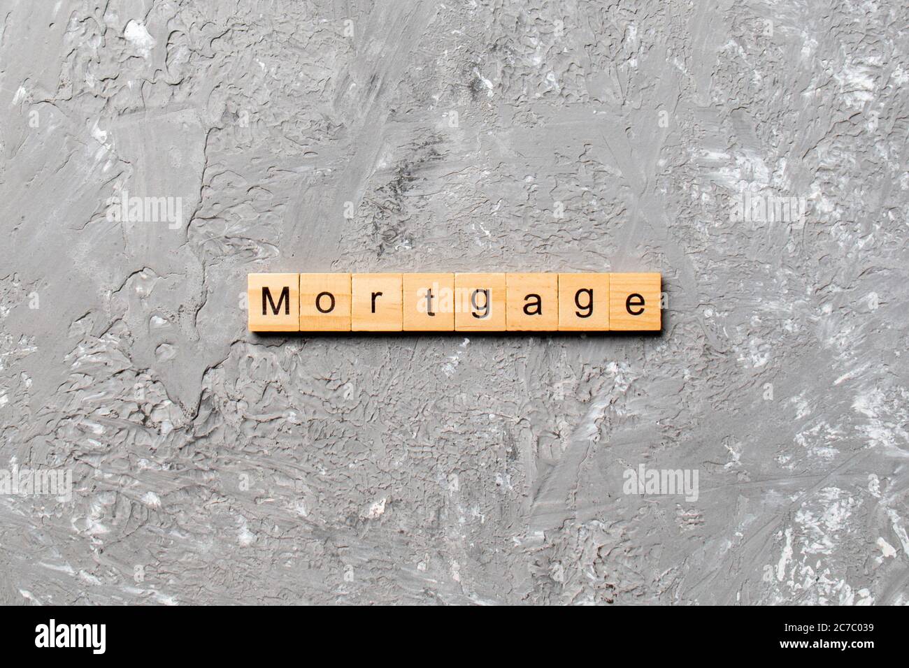 MORTGAGE word written on wood block. MORTGAGE text on cement table for ...