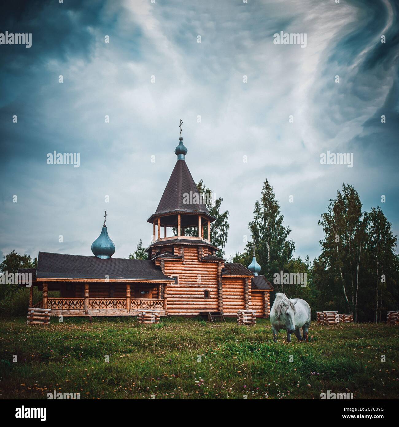 Old wooden church in Russia, Saint-Petersburg city. With horse eating ...