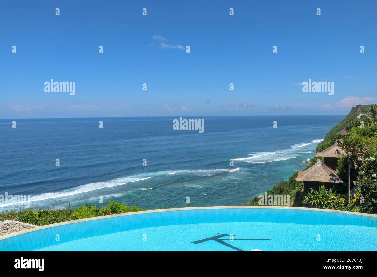 Luxury infinity pool with sea views and palm trees. Bali, Indonesia ...