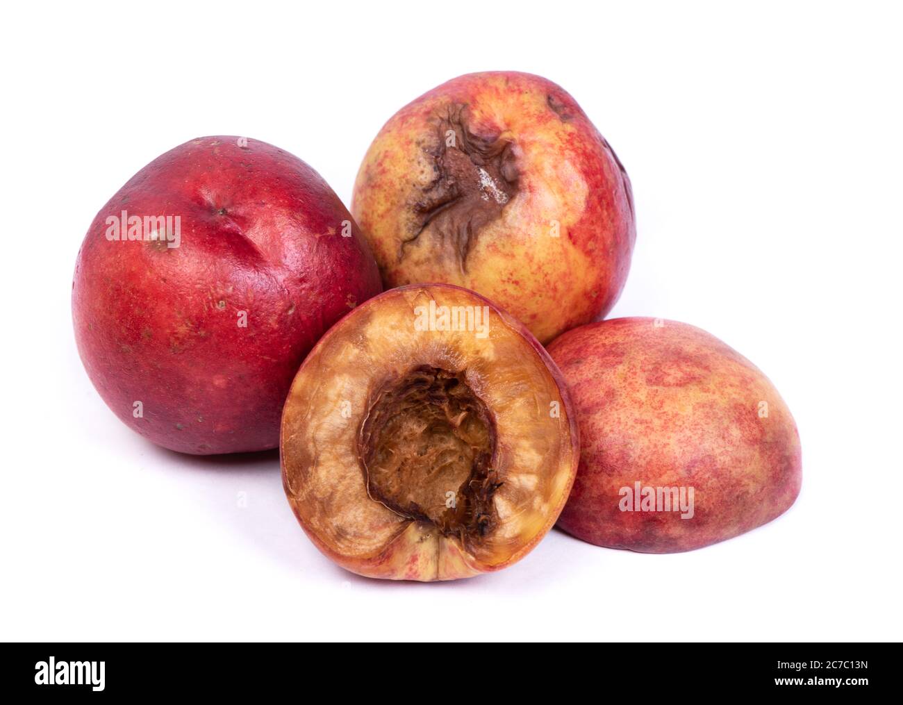 Group of rotten nectarines isolated on white background Stock Photo - Alamy