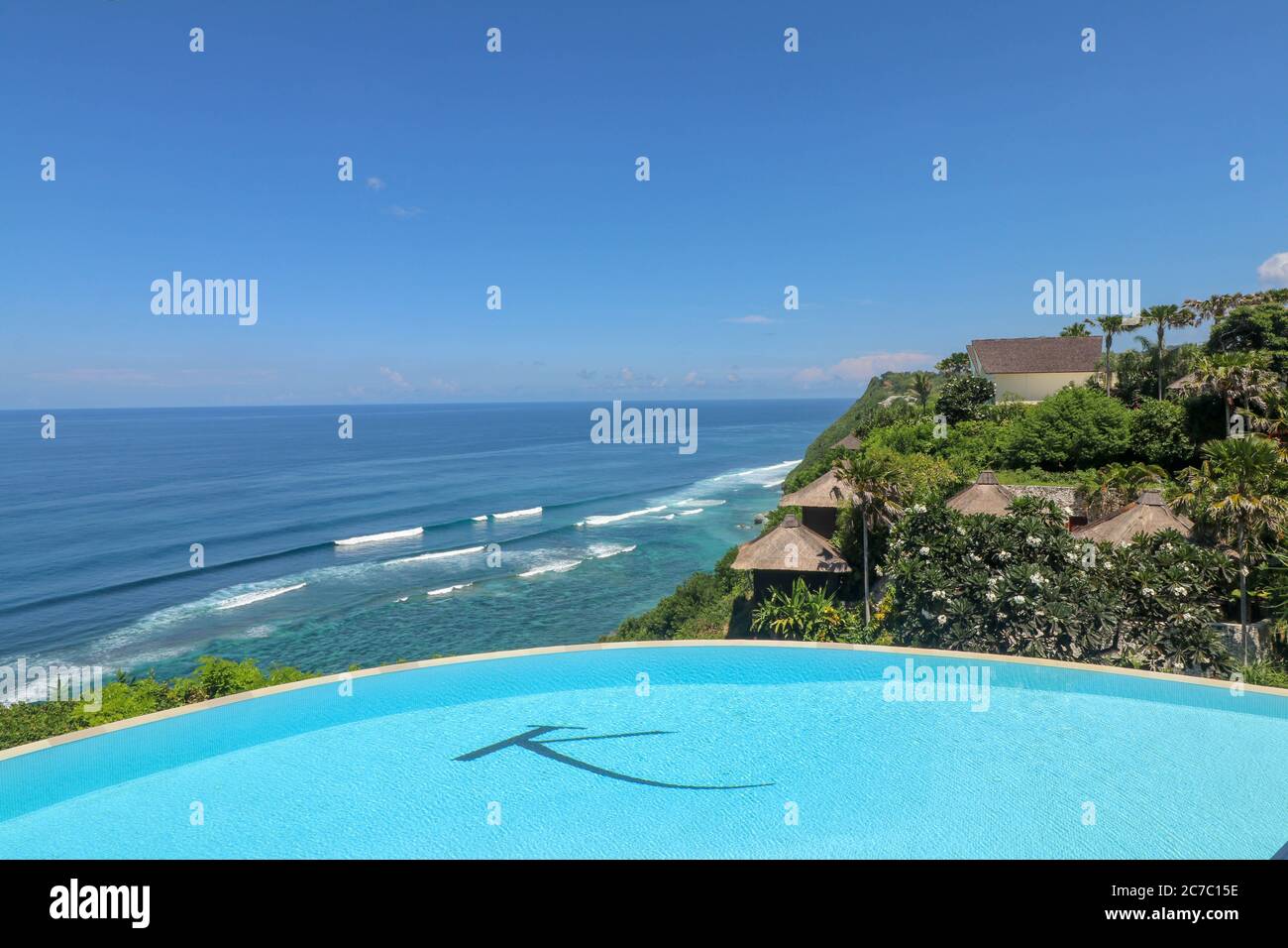 Luxury infinity pool with sea views and palm trees. Bali, Indonesia ...