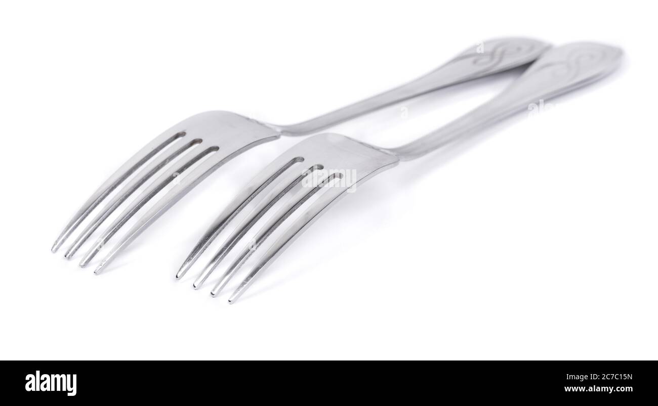 Two stainless steel forks isolated on white background Stock Photo - Alamy