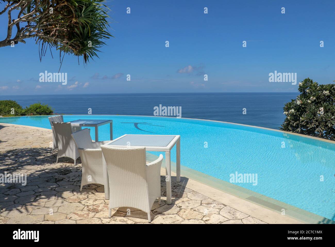 Luxury infinity pool with sea views and palm trees. Bali, Indonesia ...