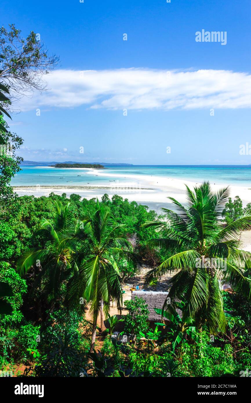 View of coastline of Iranja Island (Nosy Iranja) lined with palm trees ...