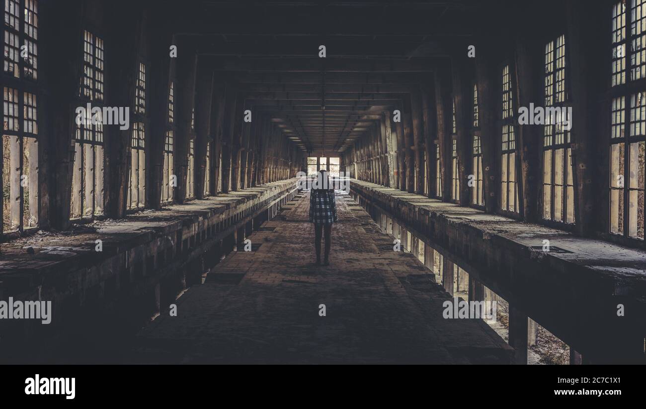 Young female standing inside an old abandoned building Stock Photo - Alamy